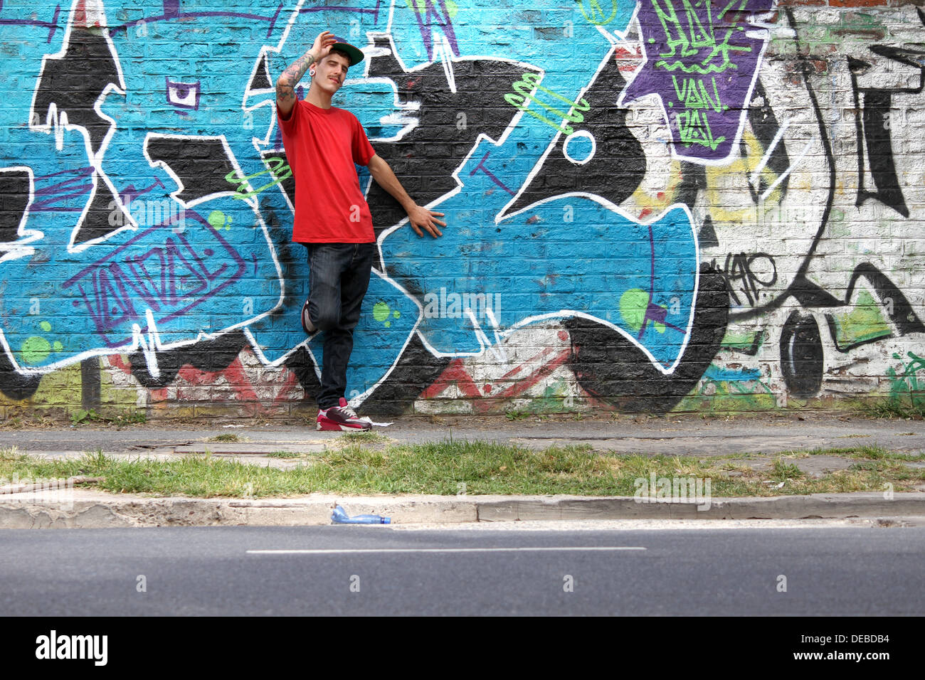 A greeting young Rapper greeting in front of a Graffiti wall Stock ...