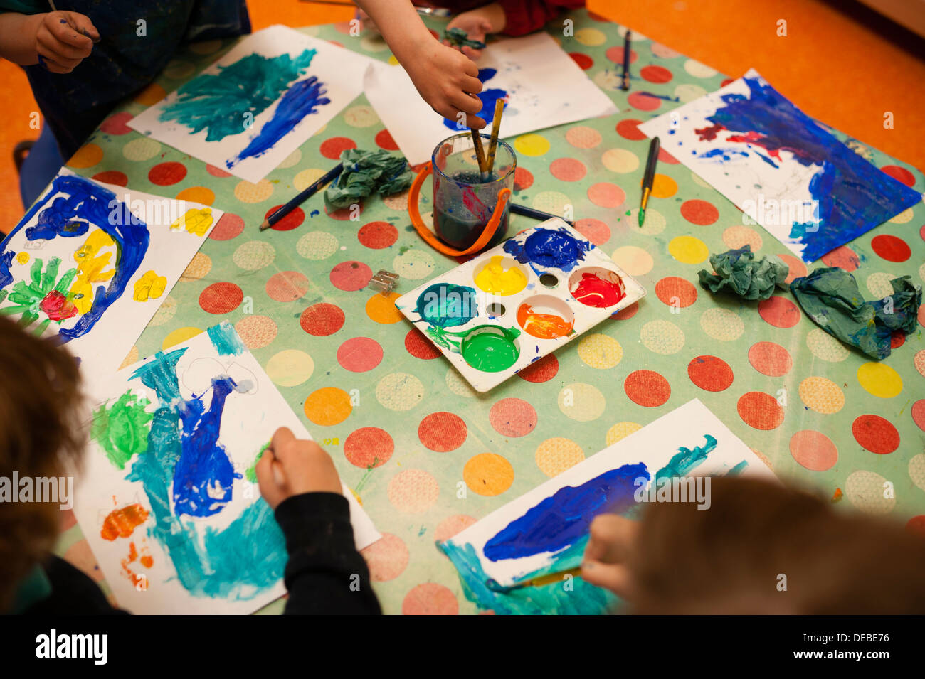 Pupils painting in an art class lesson in a primary school, Wales UK ...
