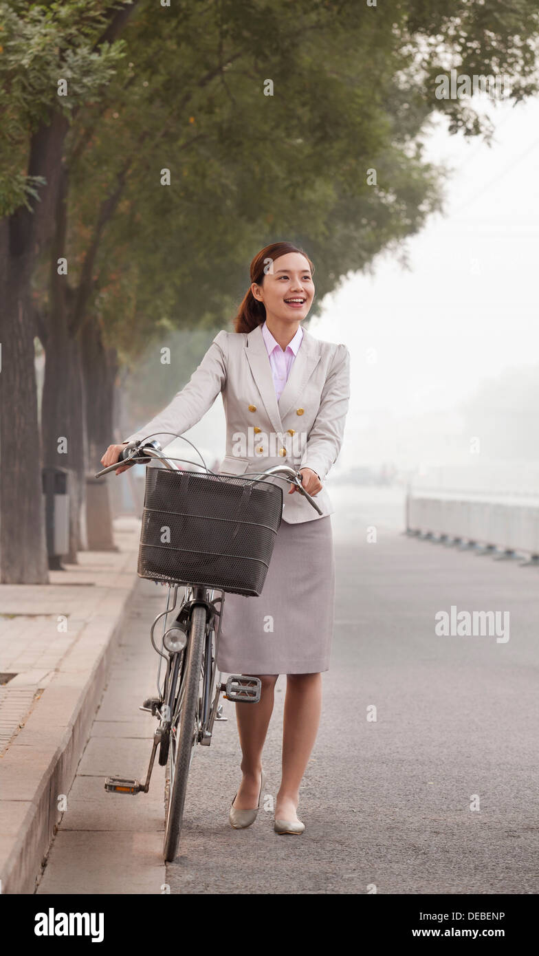 Young Business Woman commuting with a Bicycle, Beijing, China Stock ...