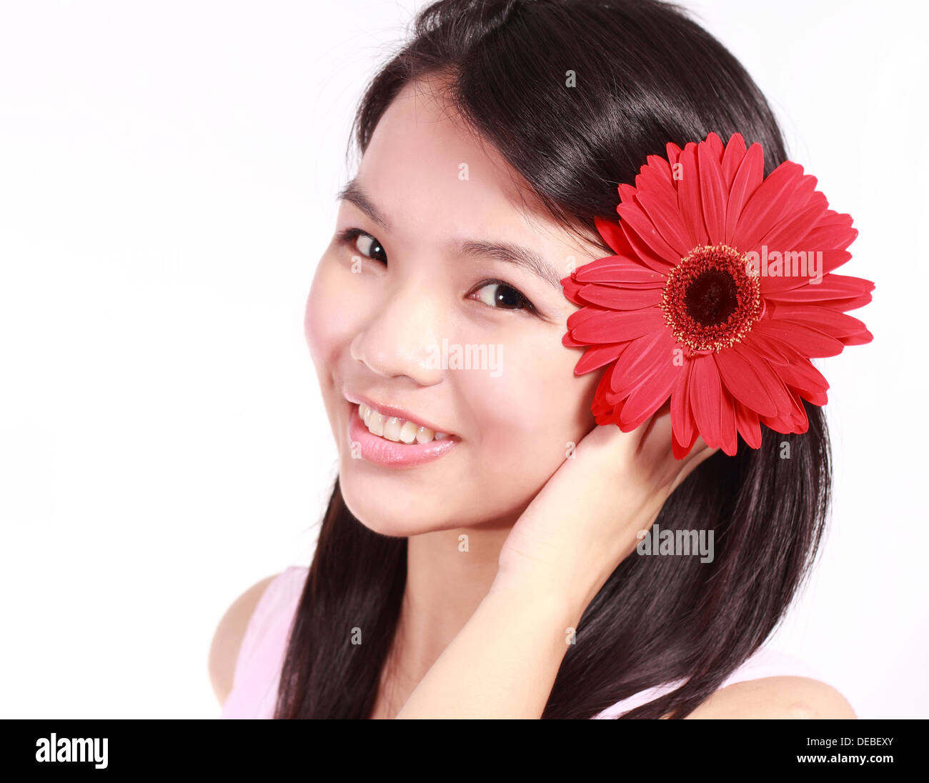 Beautiful young lady with gerbera flower isolated on white background ...