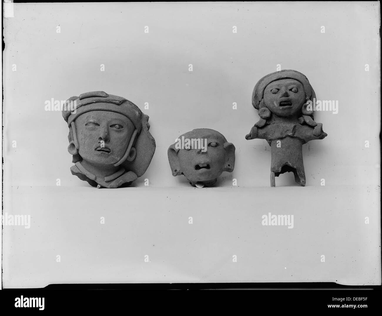 This image shows a collection of pottery heads from Mexico ...