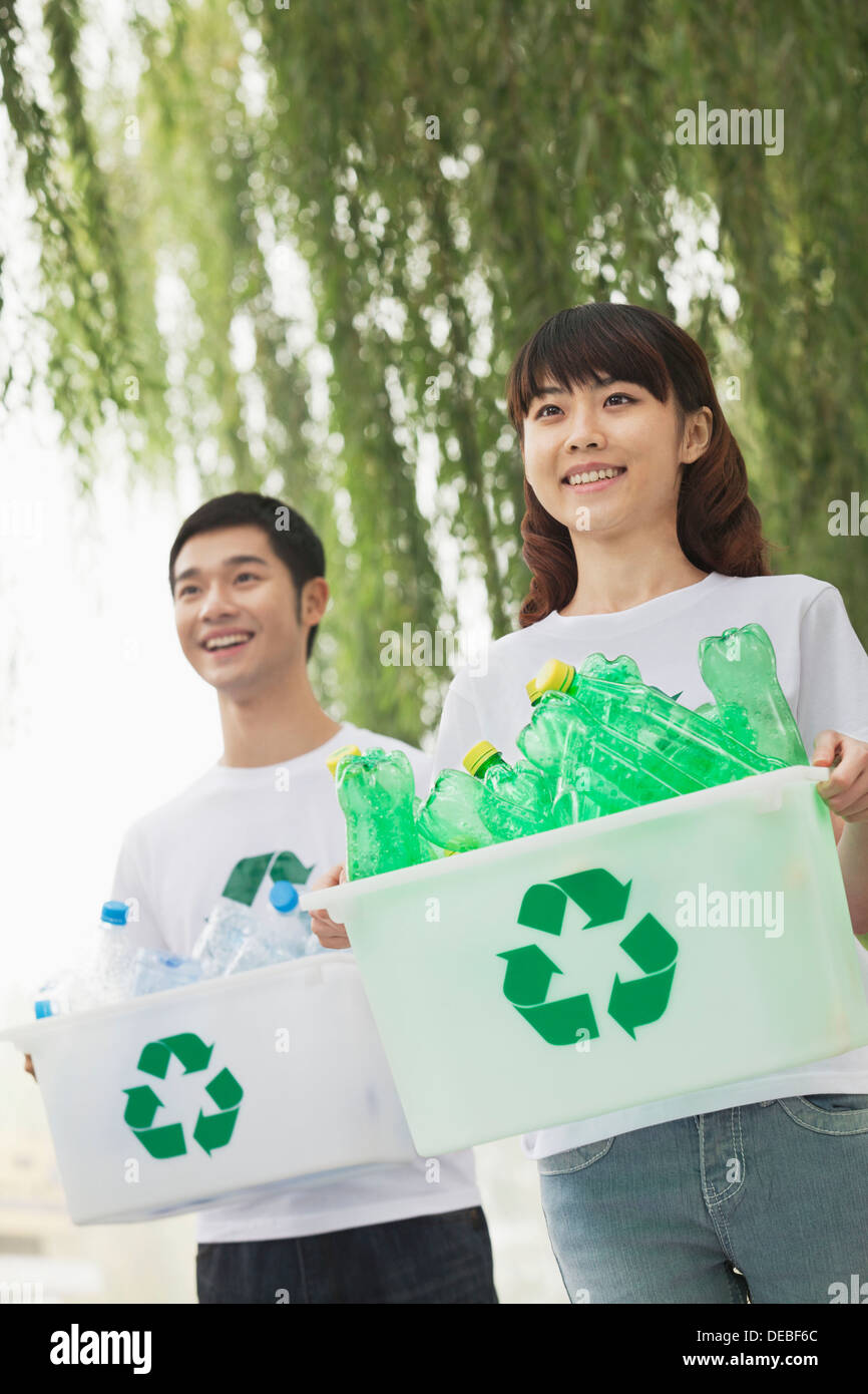 Two Young People Recycling Plastic Bottles Stock Photo - Alamy
