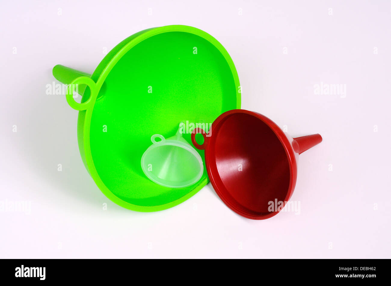 Three plastic funnels against a white background Stock Photo - Alamy