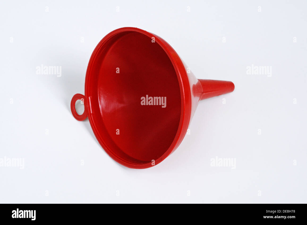 Red plastic funnel against a white background Stock Photo - Alamy