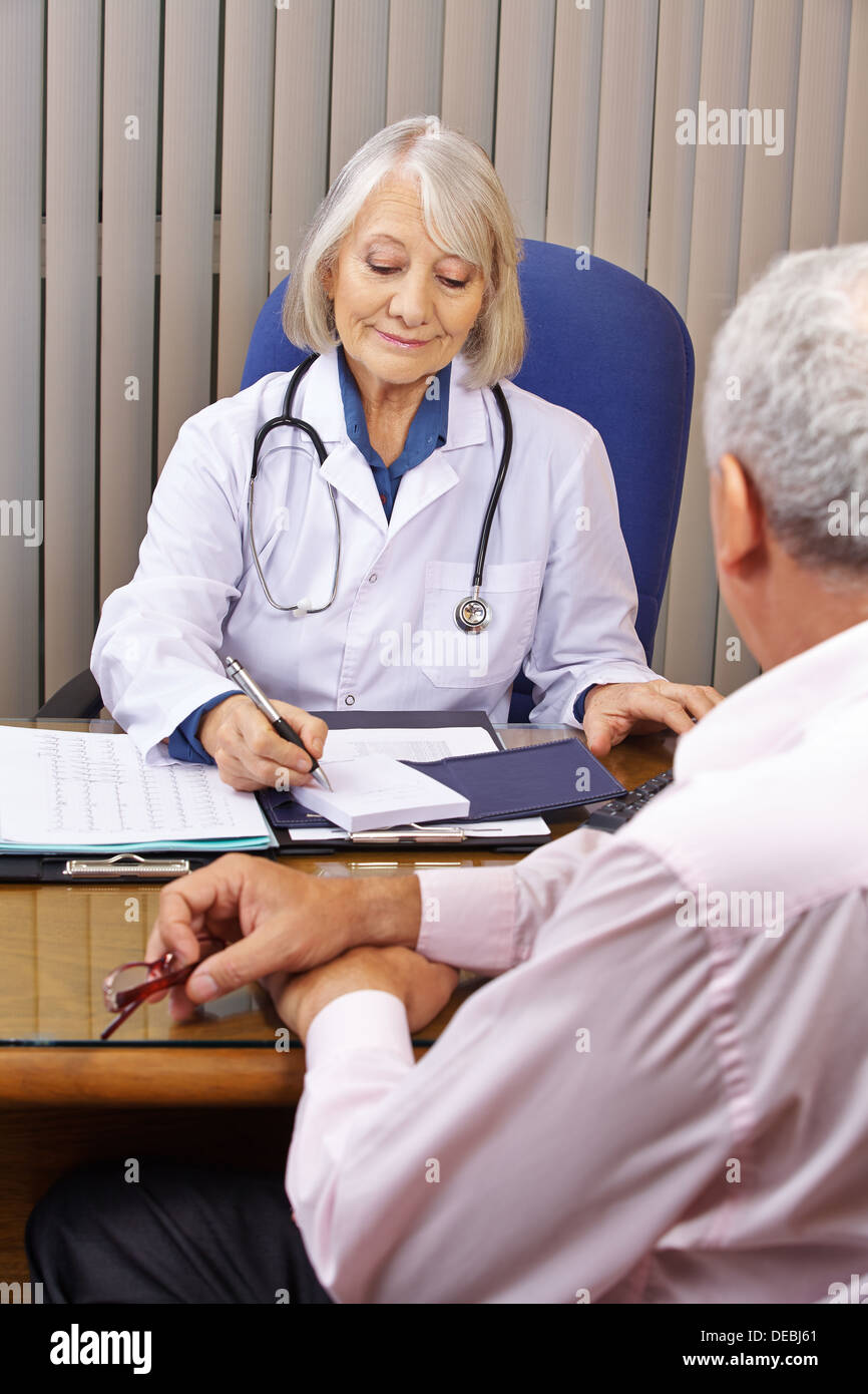 Doctor in office giving consultation to a senior patient Stock Photo ...