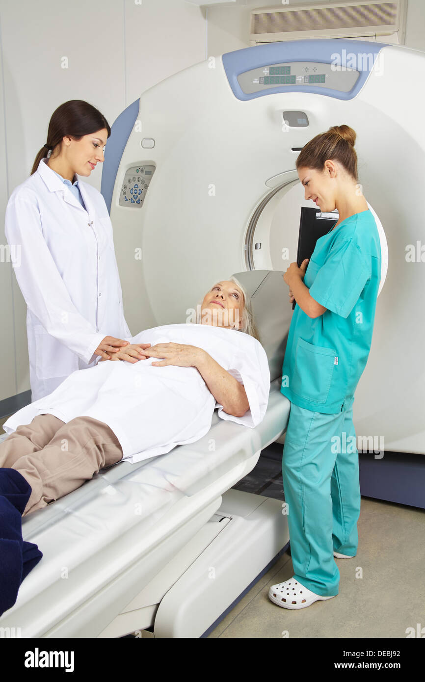 Doctor and nurse talking to patient prior to a magnetic resonance ...