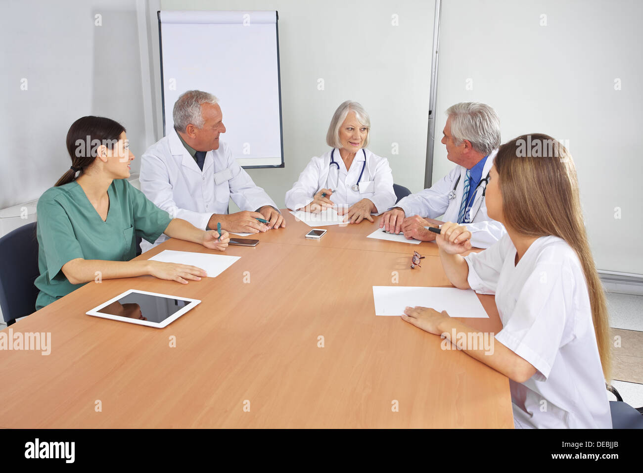 Doctor making work schedule in team meeting with colleagues Stock Photo ...
