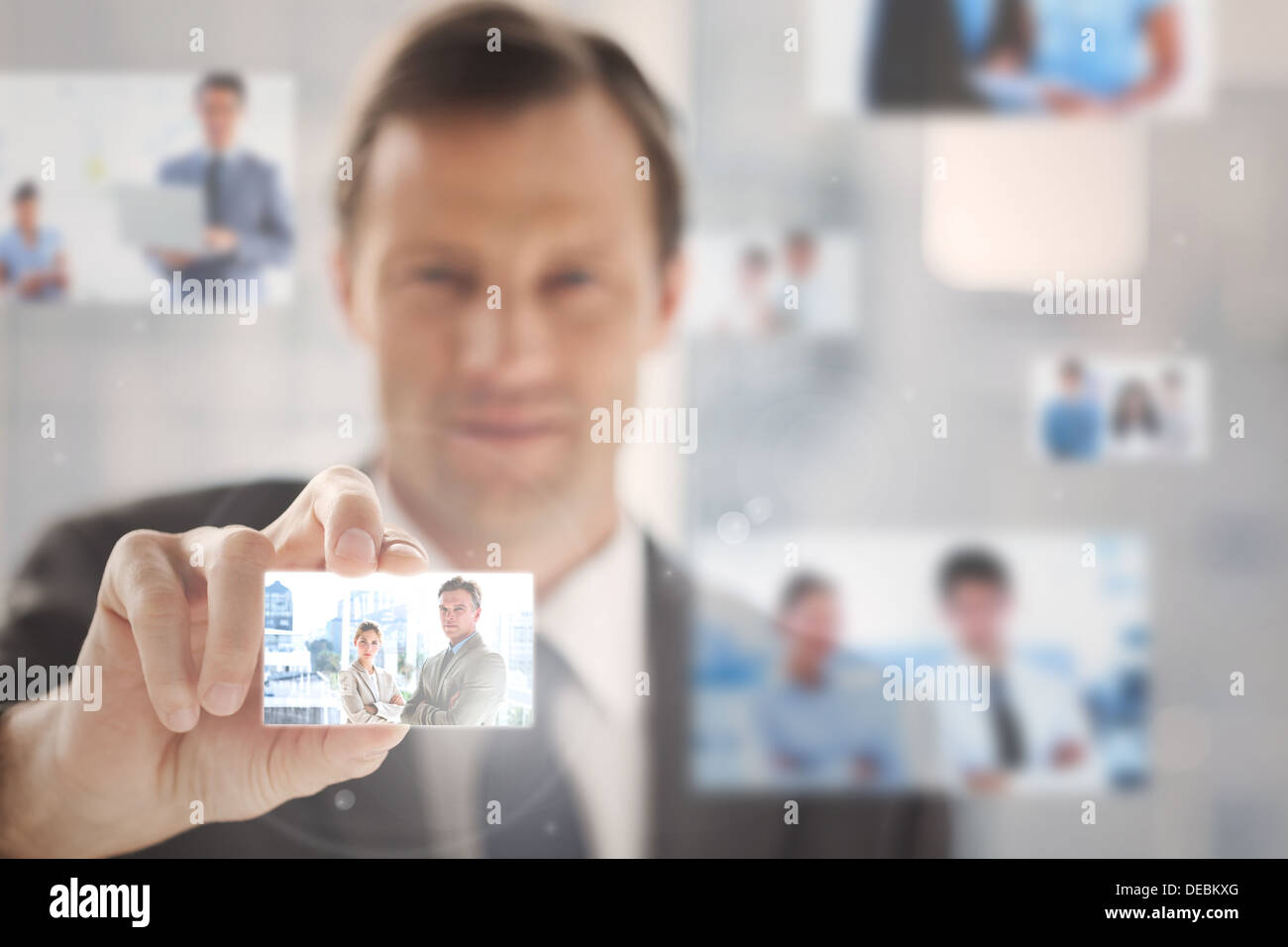 Pleased businessman picking a picture Stock Photo - Alamy