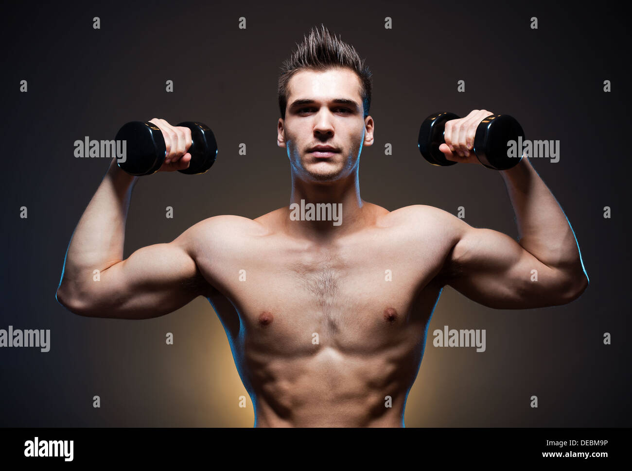 Dark moody portrait of very fit ripped young athlete Stock Photo - Alamy