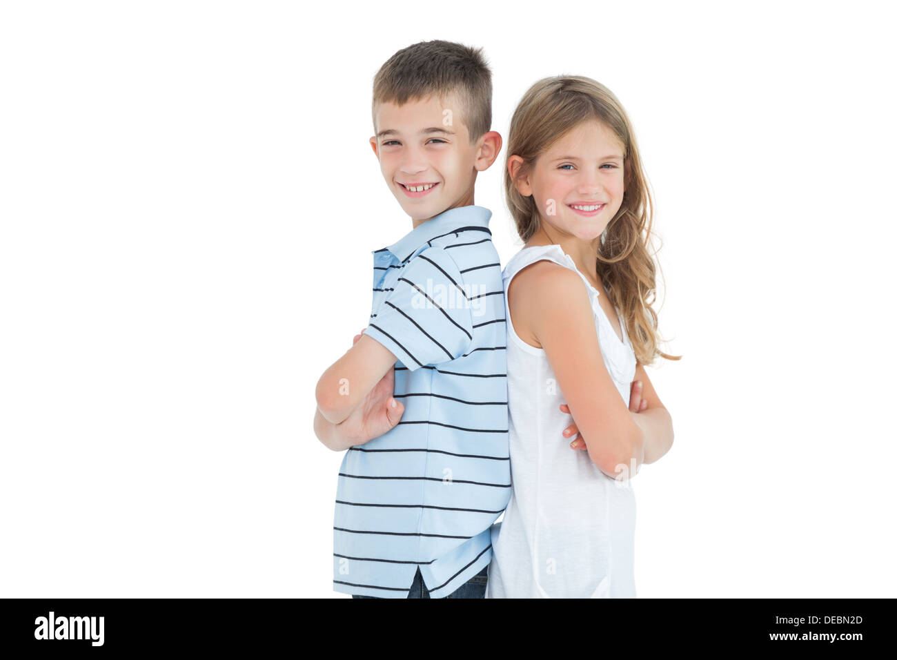 Happy young brother and sister posing back-to-back Stock Photo - Alamy