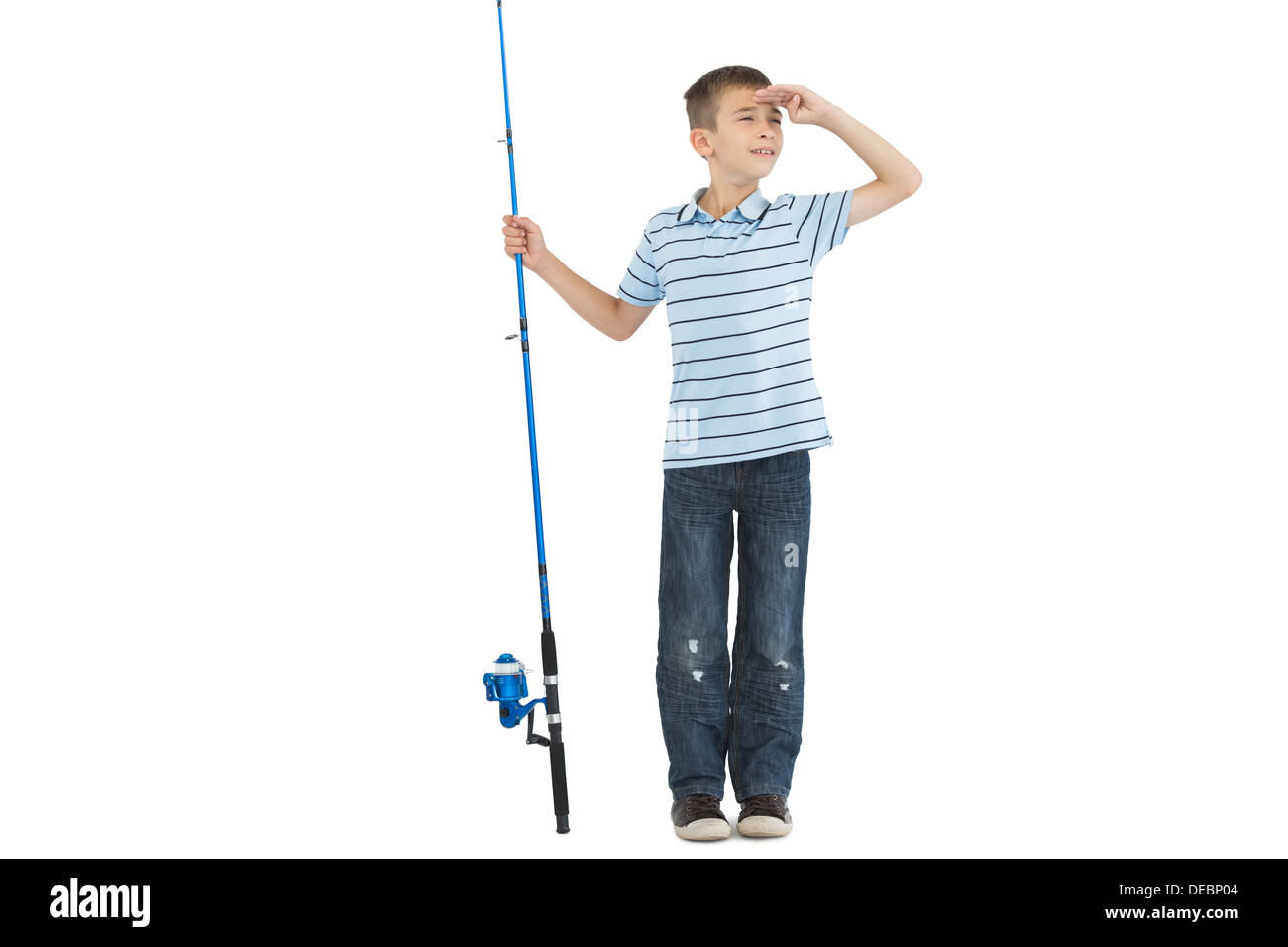 Young boy holding fishing rod looking away Stock Photo - Alamy
