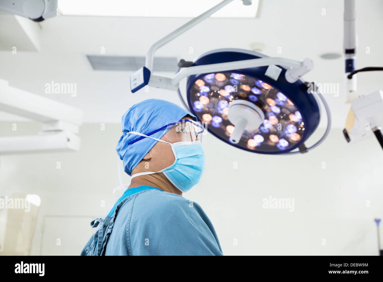 Side view of surgeon wearing a surgical mask and glasses in the ...