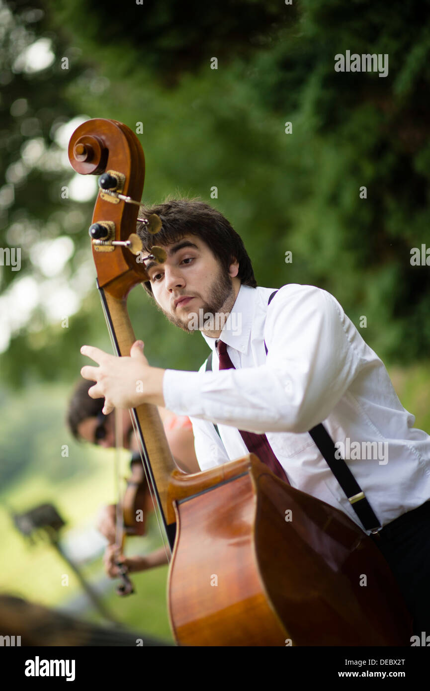 a man playing acoustic double bass in an outdoor jazz swing band UK ...