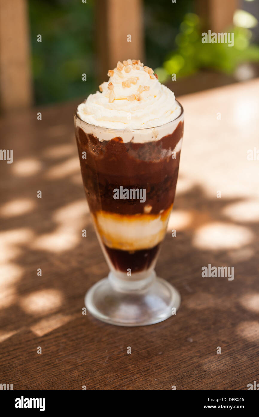 Chocolate sundae with whipped cream and chopped nuts Stock Photo - Alamy