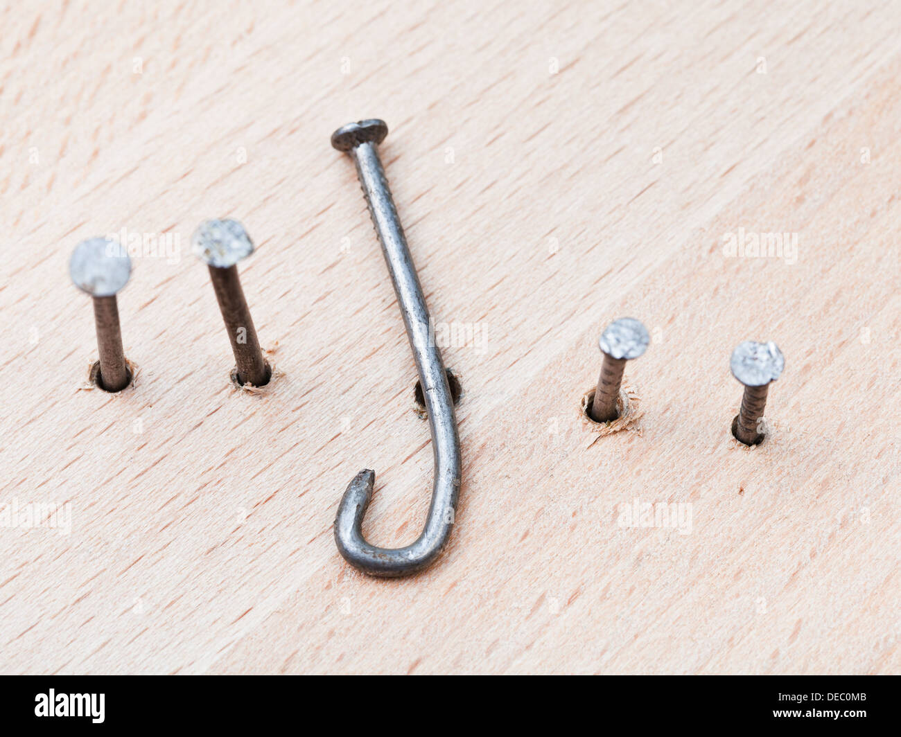 top view of line of nails and curved nail Stock Photo - Alamy