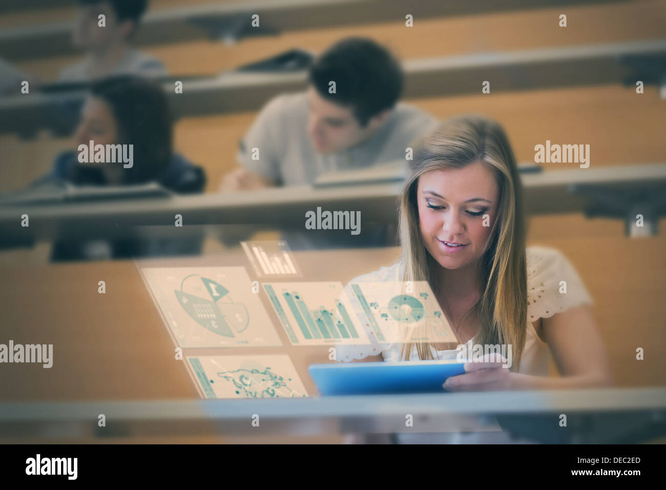 Pretty student analysing graphs on her digital tablet Stock Photo - Alamy