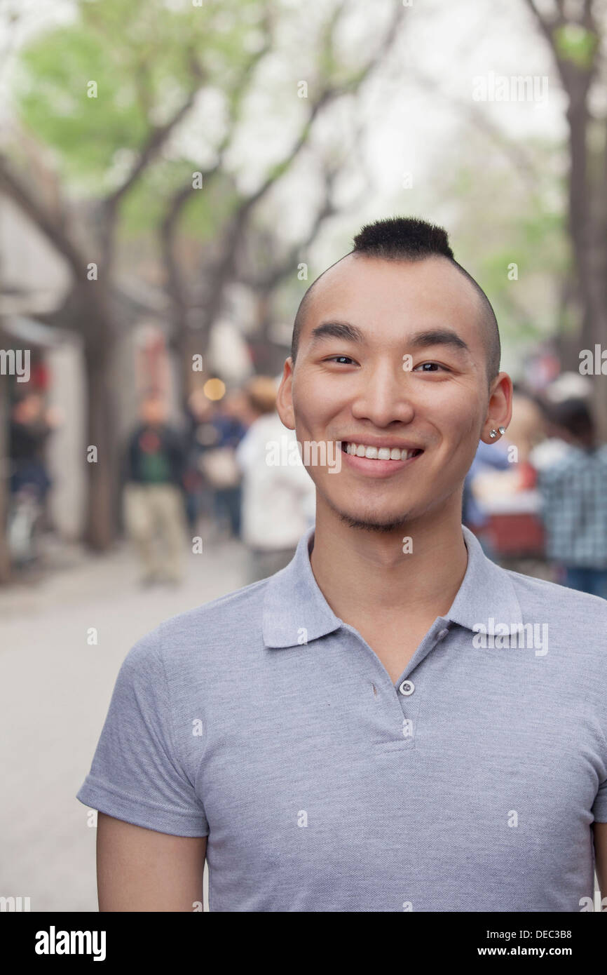 Young Man with Mohawk haircut smiling looking at camera Stock Photo - Alamy