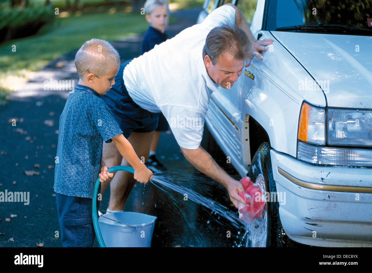 Boy helping father washing car High Resolution Stock Photography and ...