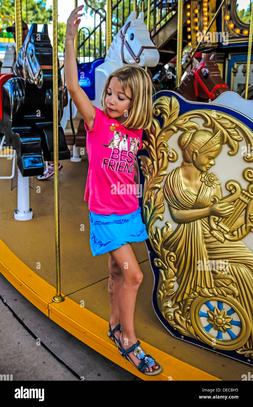 Young girl enjoys a ride on a carousel at the Legoland Theme Park ...