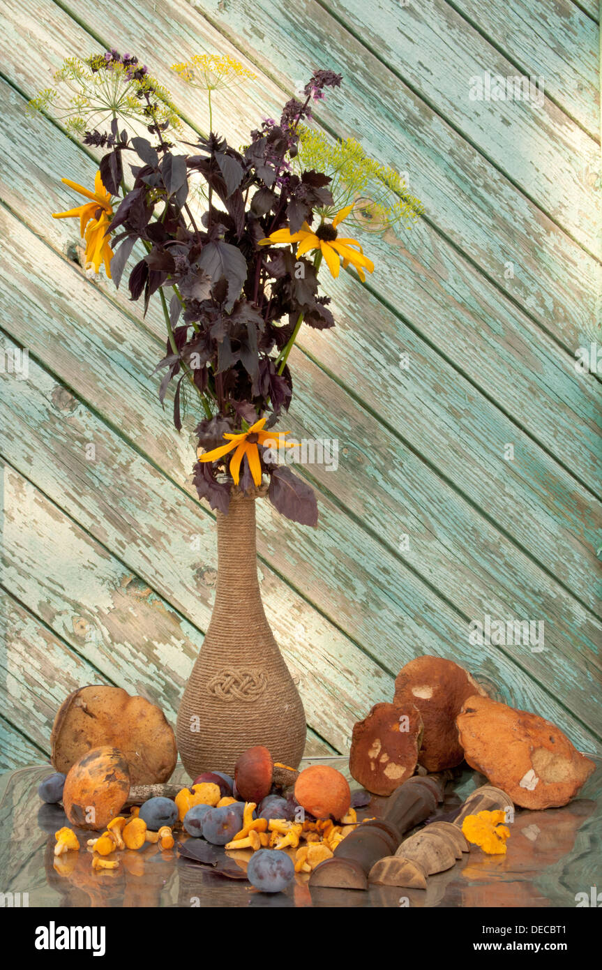basil, dill and cone flowers bouquet in a vintage vase with mushrooms ...