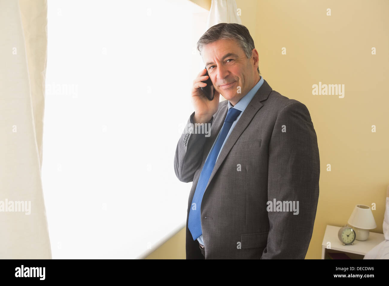 Pleased man calling someone with his mobile phone Stock Photo - Alamy