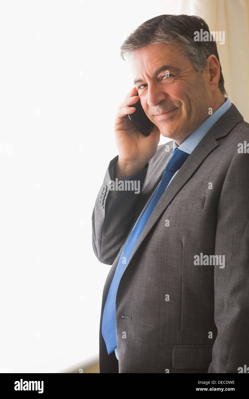Content man calling someone with his mobile phone Stock Photo - Alamy