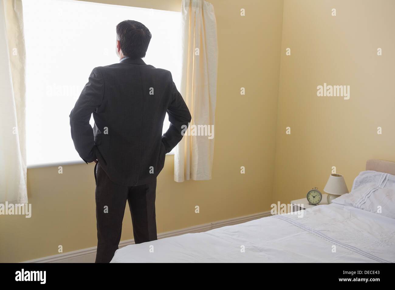 Man standing in front of the window Stock Photo - Alamy