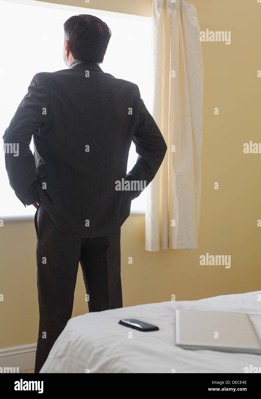 Man standing in front of window Stock Photo - Alamy