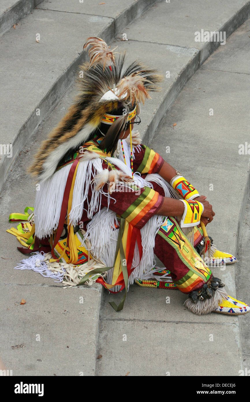 A First Nations round dancer resting during a pow wow in Winnipeg ...