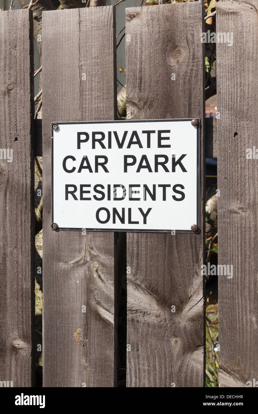 Private car park residents only sign fastened to a wooden fence Stock ...