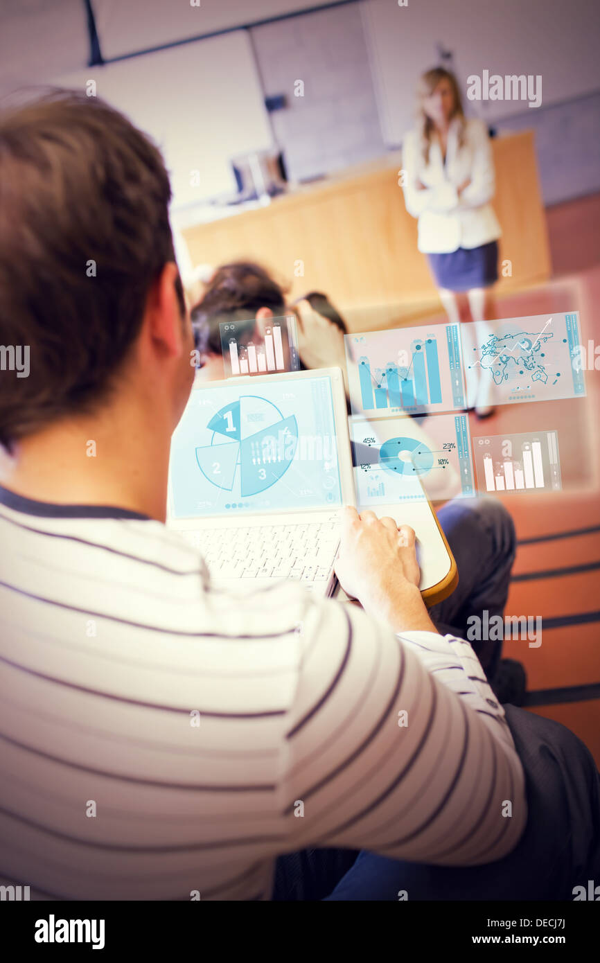 Serious student analysing graphs on his futuristic notebook Stock Photo ...