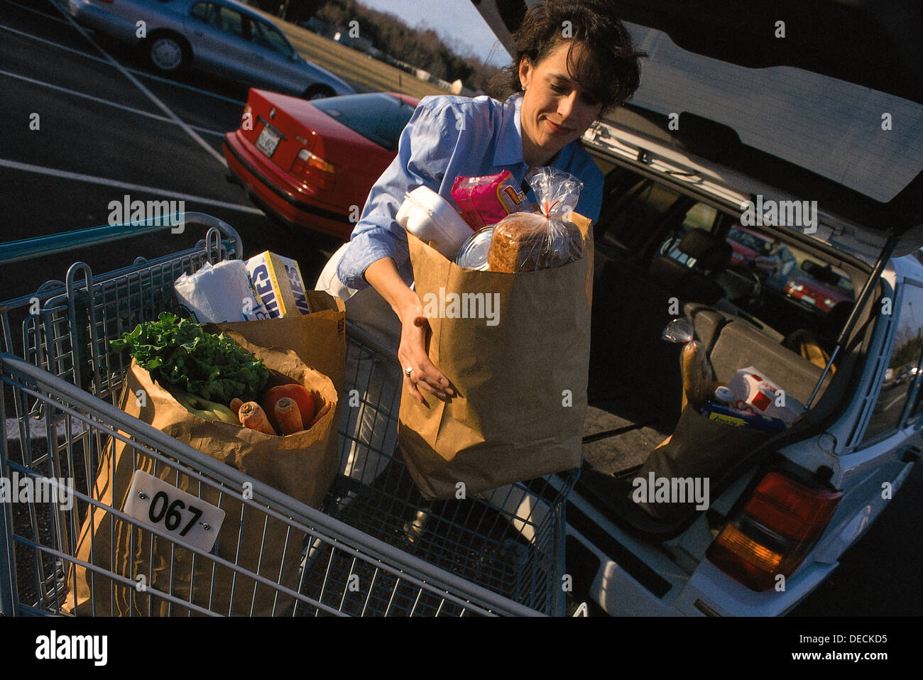 Woman Unloading Trolley High Resolution Stock Photography and Images ...
