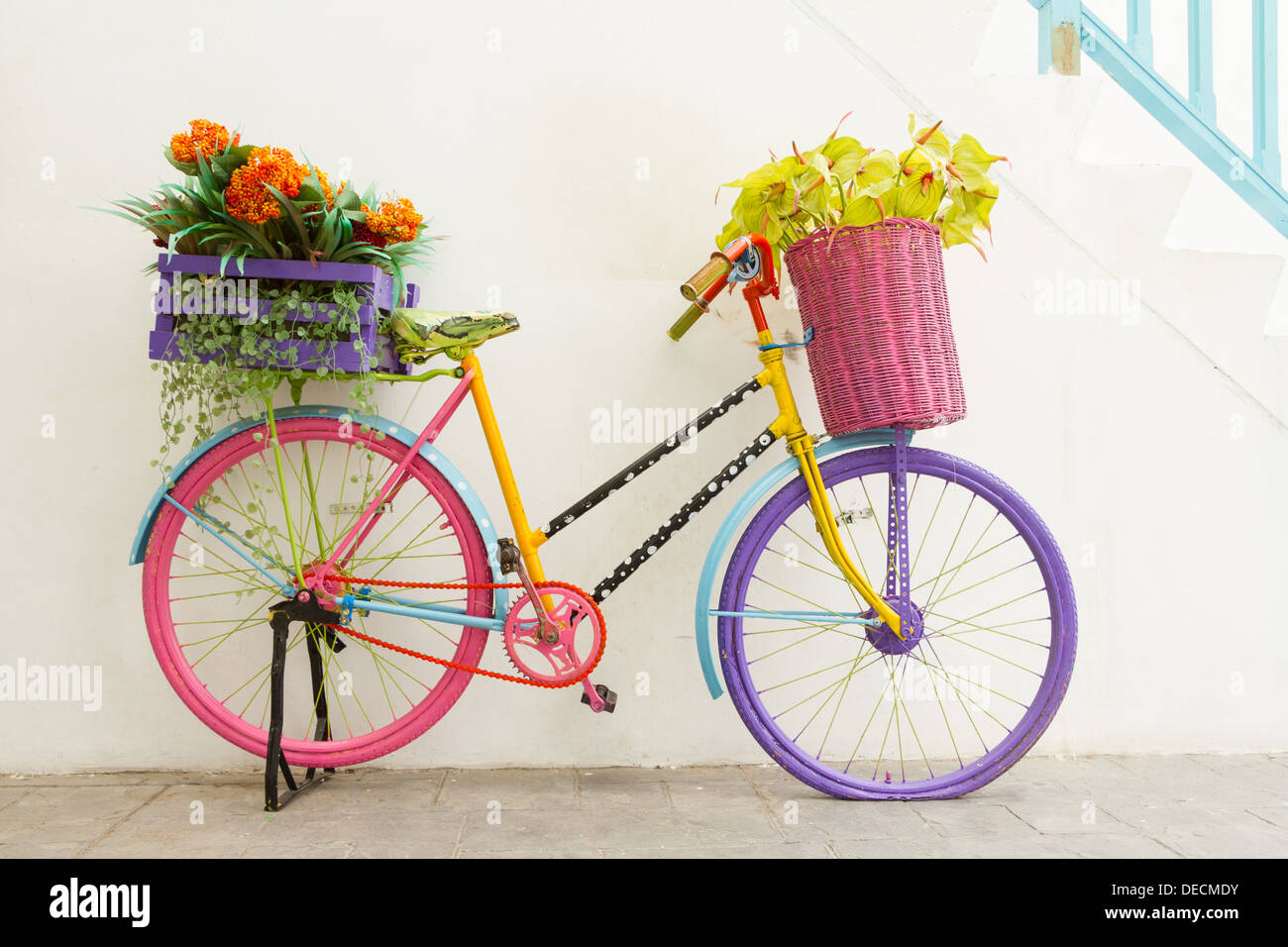 Colorful bicycles with bunches of flowers Stock Photo - Alamy