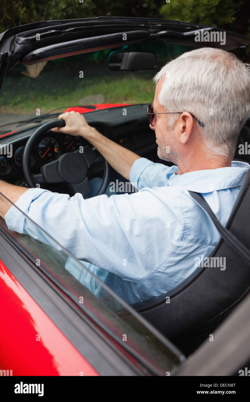 Handsome man driving his red convertible Stock Photo - Alamy