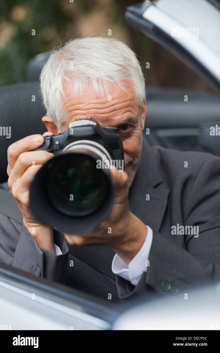 Mature paparazzi taking picture with professional camera Stock Photo ...