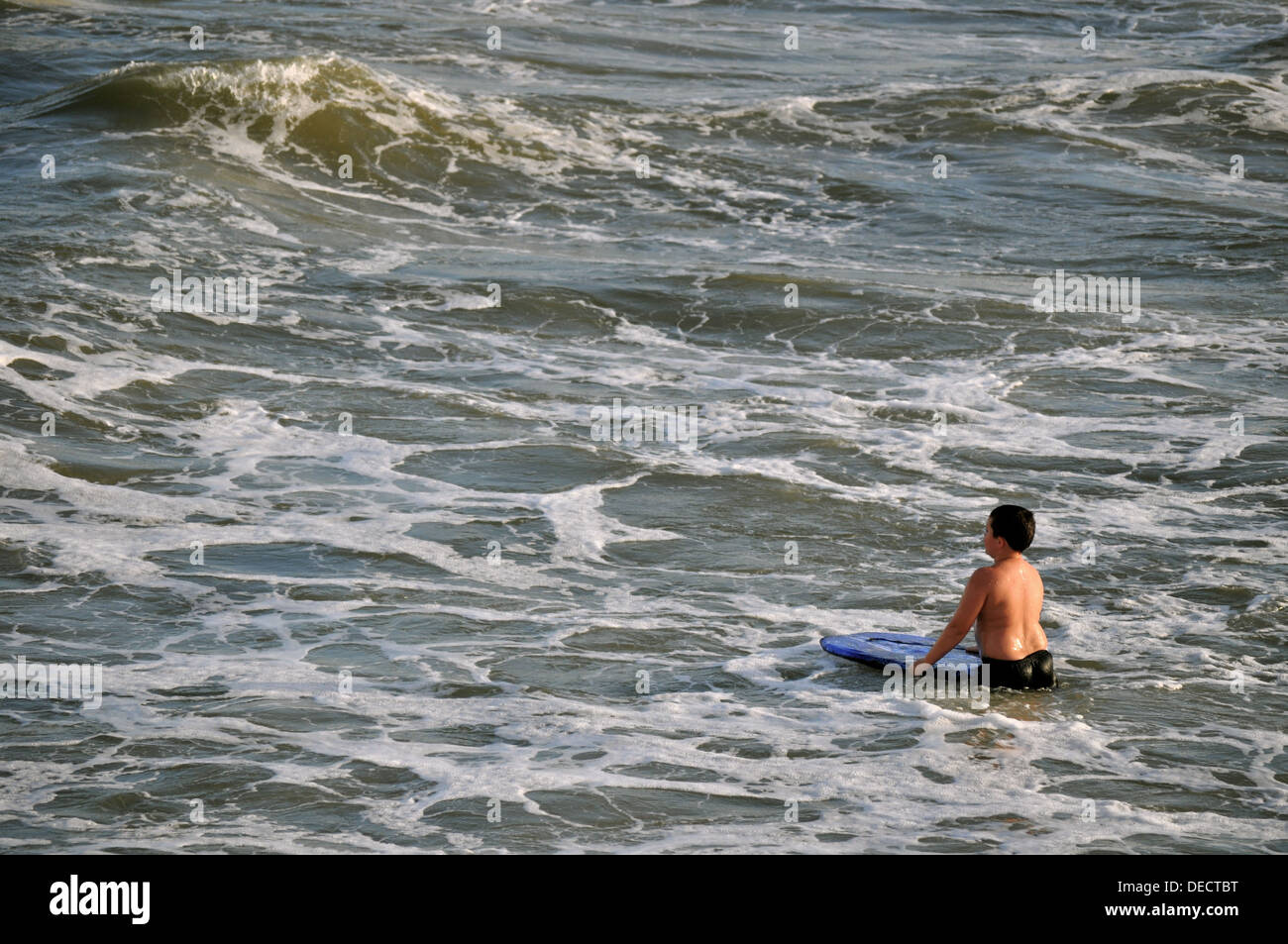 Boy in the waves Stock Photo - Alamy