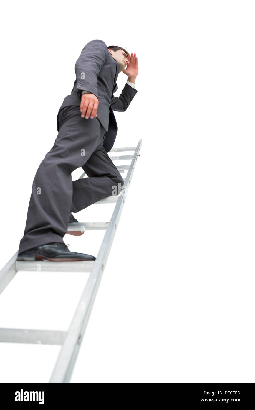 Low angle view of businessman standing on ladder Stock Photo - Alamy