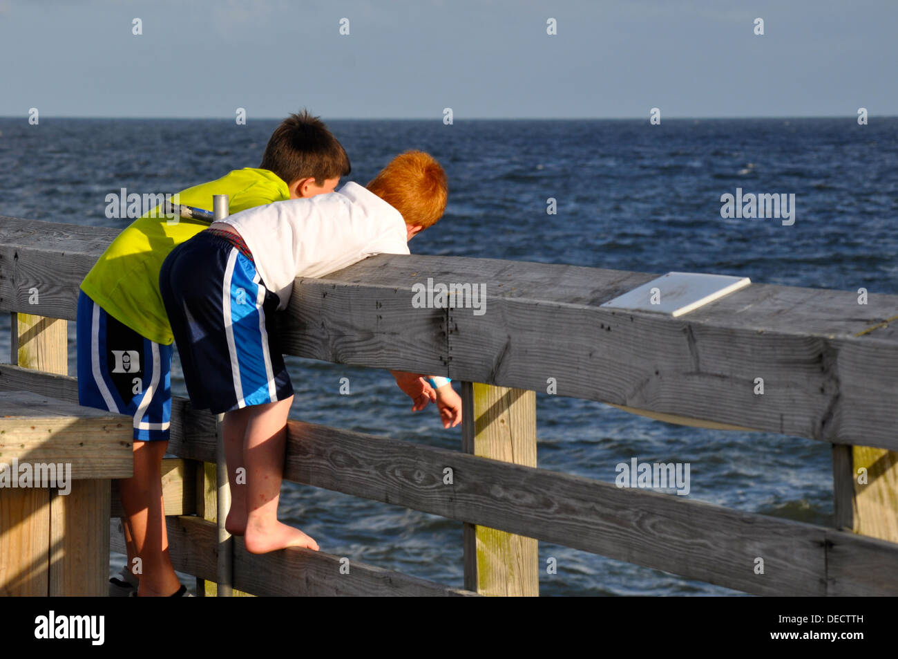 Boys fishing on the Pier Stock Photo - Alamy