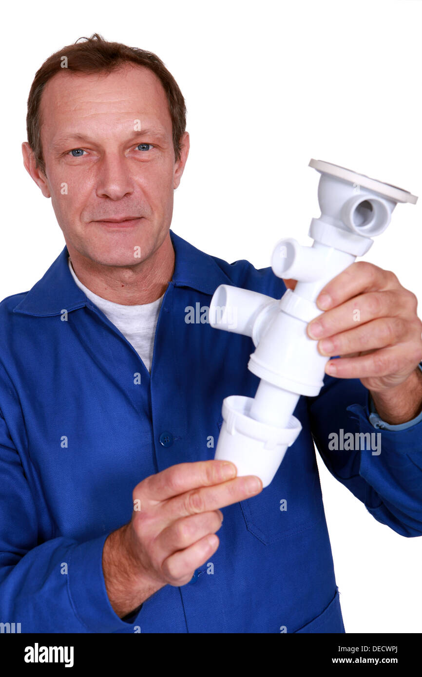 Plumber holding replacement part Stock Photo - Alamy