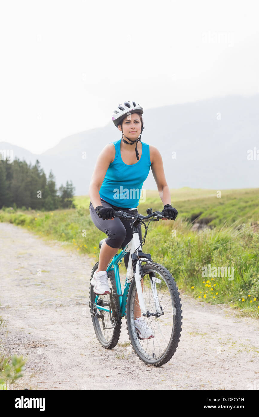 Fit woman riding mountain bike Stock Photo - Alamy