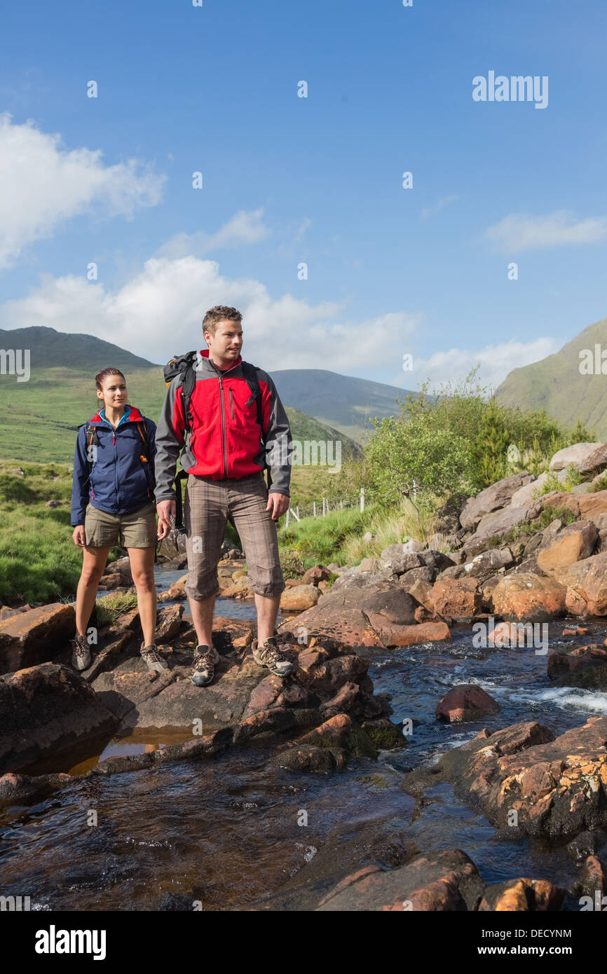 Woman hiking crossing river stream hi-res stock photography and images ...