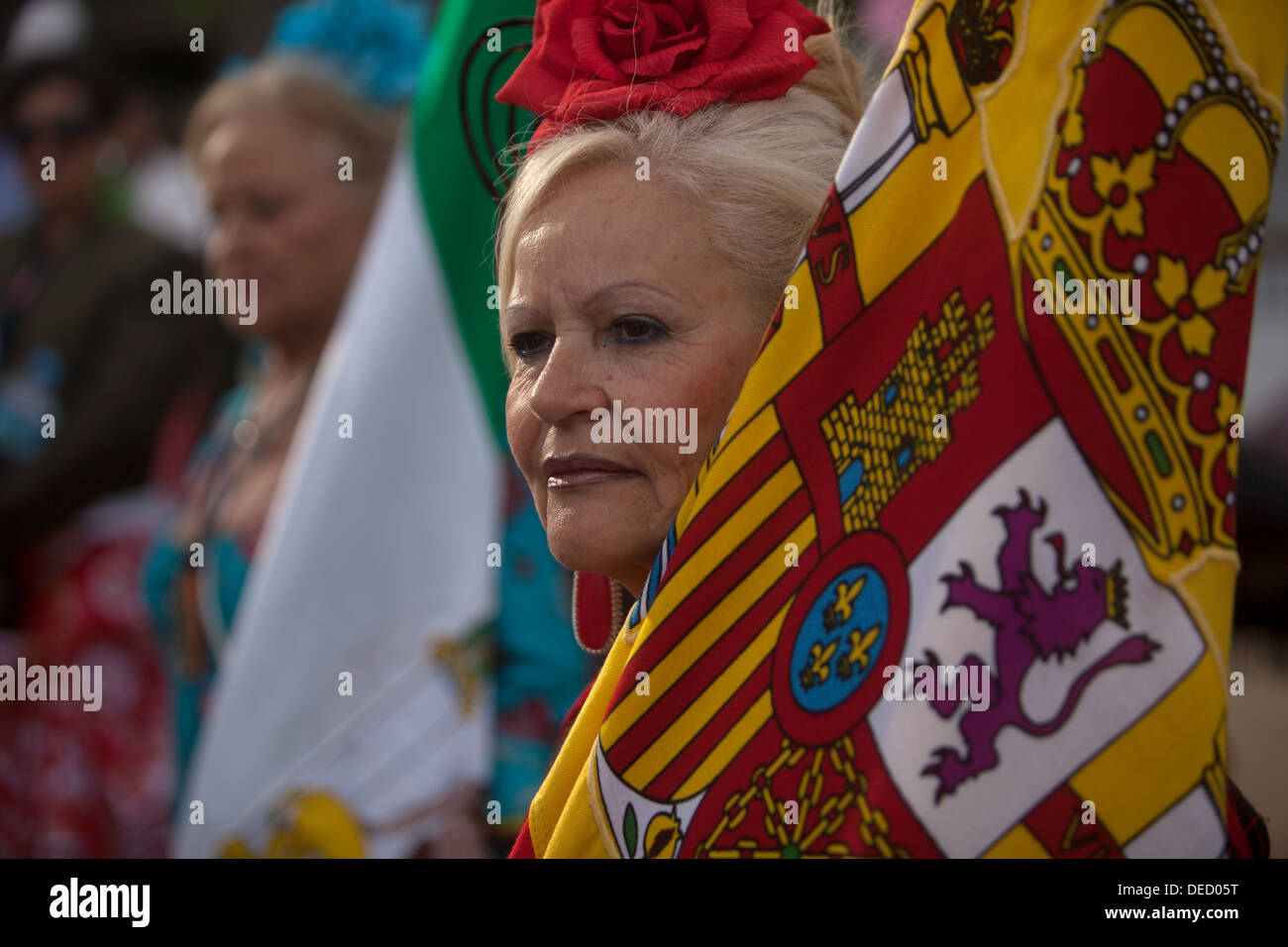 A senior female pilgrim holds the Spanish flag during the pilgrimage to ...