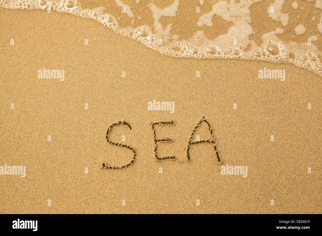 Sea - written by hand in sand on a sea beach Stock Photo - Alamy
