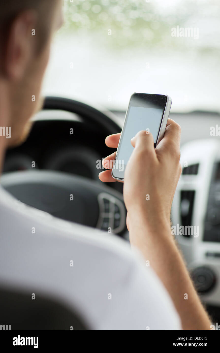 man using phone while driving the car Stock Photo - Alamy