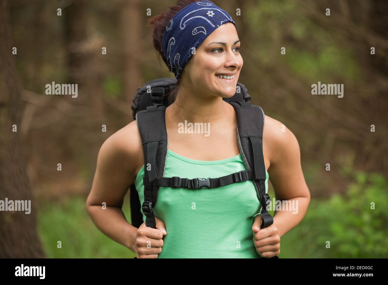 Happy woman standing in a forest Stock Photo - Alamy