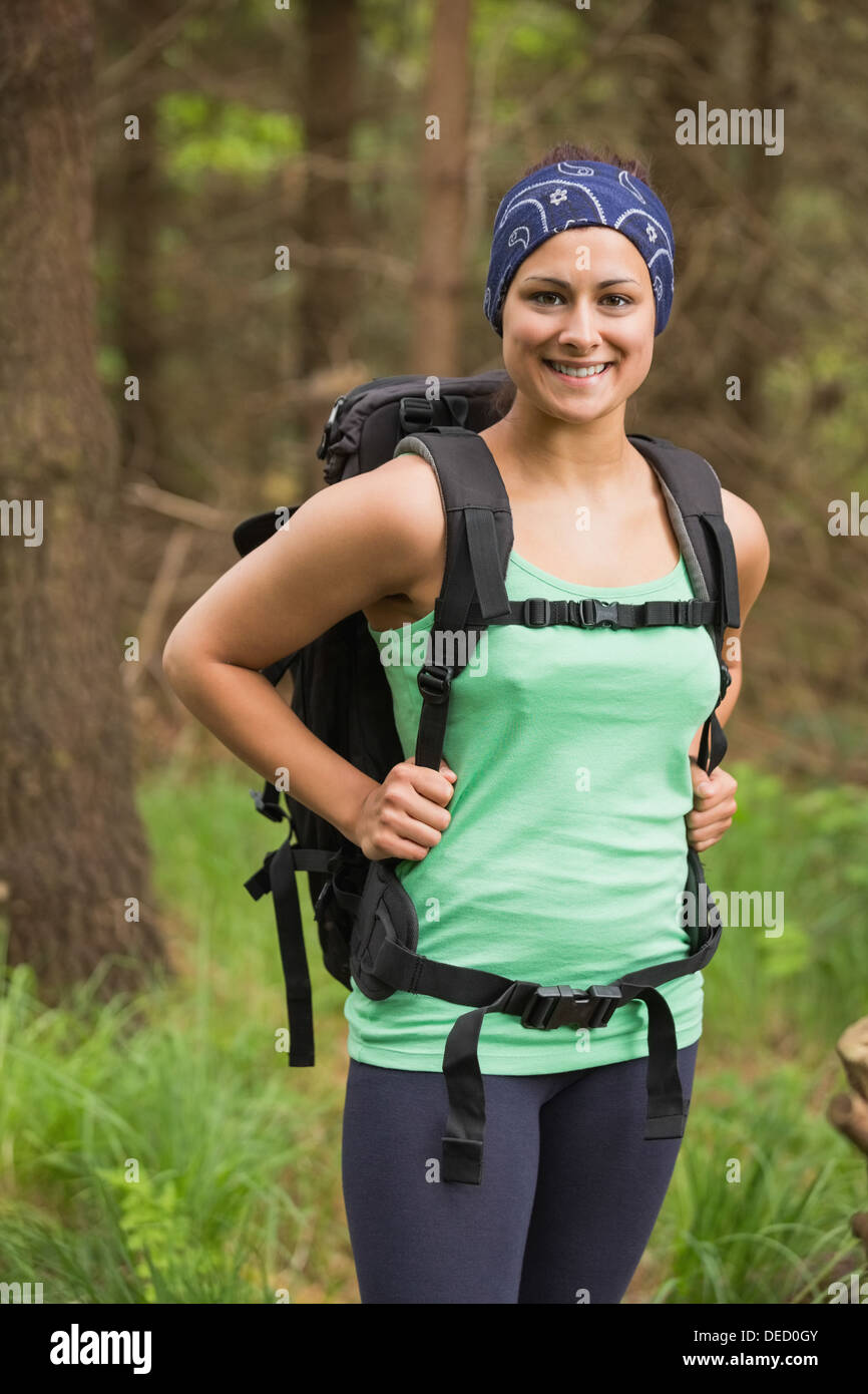 Pretty woman standing in a forest on hike Stock Photo - Alamy
