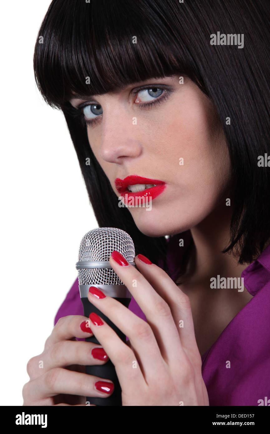 female singer caressing a micro Stock Photo - Alamy