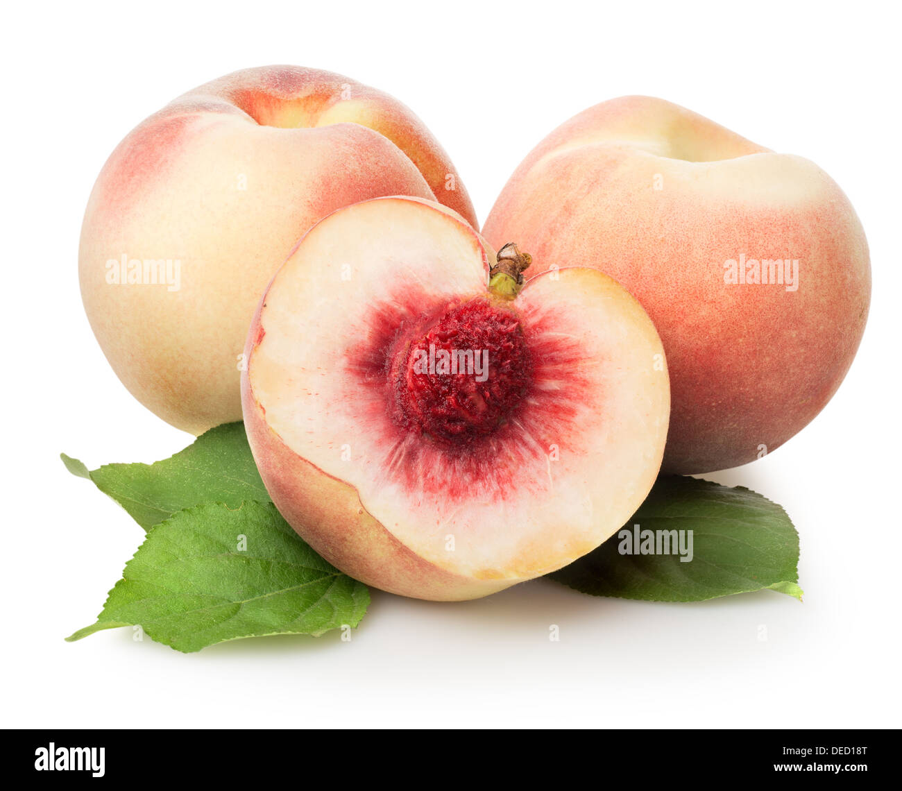 Three peaches with green leaves isolated on white Stock Photo - Alamy