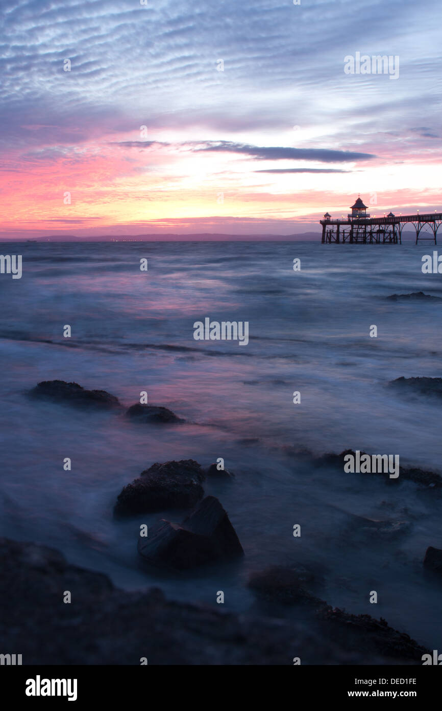 CLEVEDON PIER:The colour reflects in the sea as the sky turns red and ...