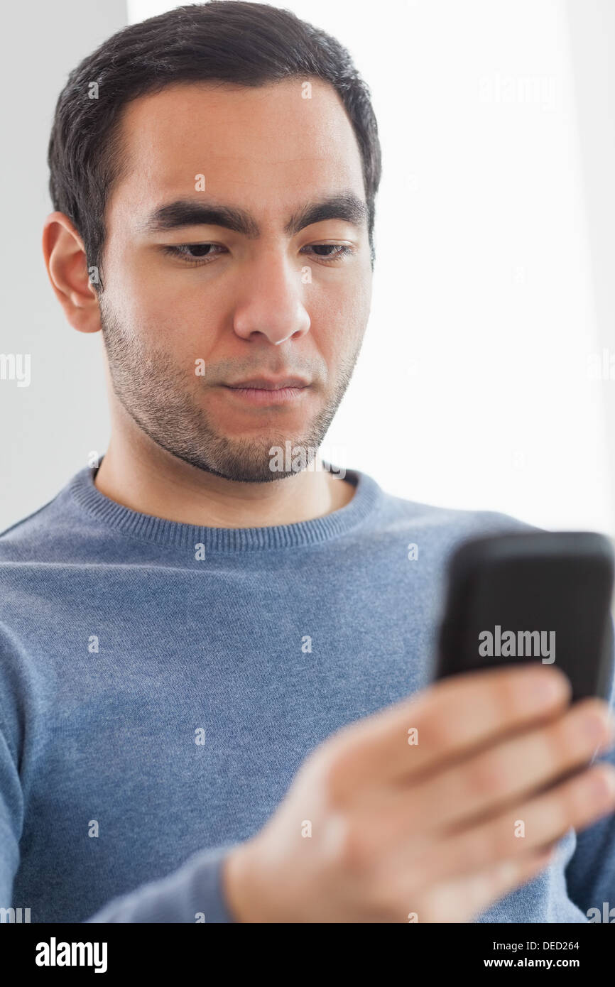 Serious casual man text messaging Stock Photo - Alamy